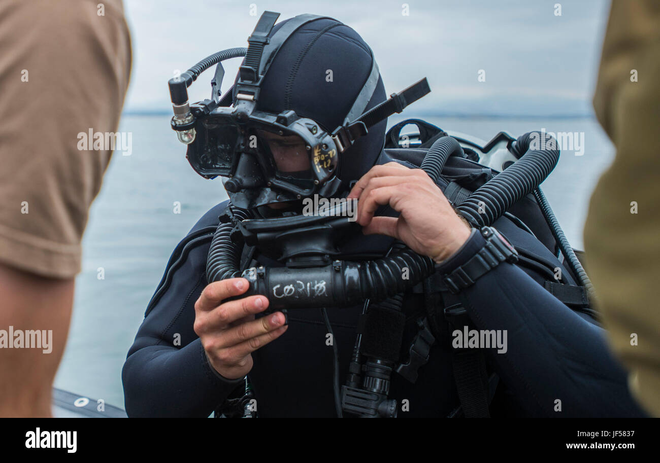 A U.S. Navy Sailor assigned to Explosive Ordnance Disposal Group One (EODGRU 1) "mask up" his MK ...