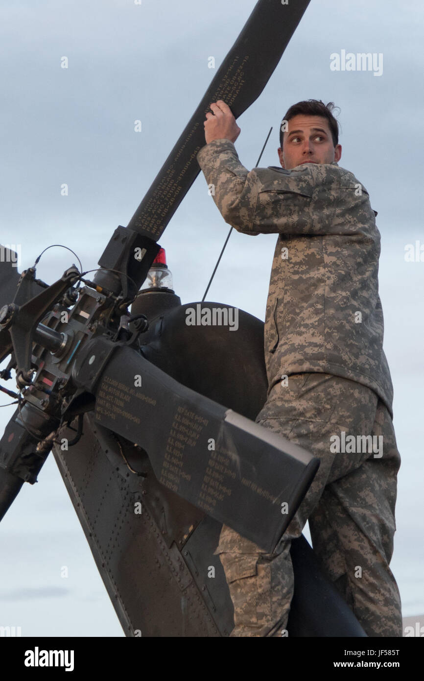 Capt. Timothy Swenson, HHC 1-224 Aviation, helps complete a pre-flight ...