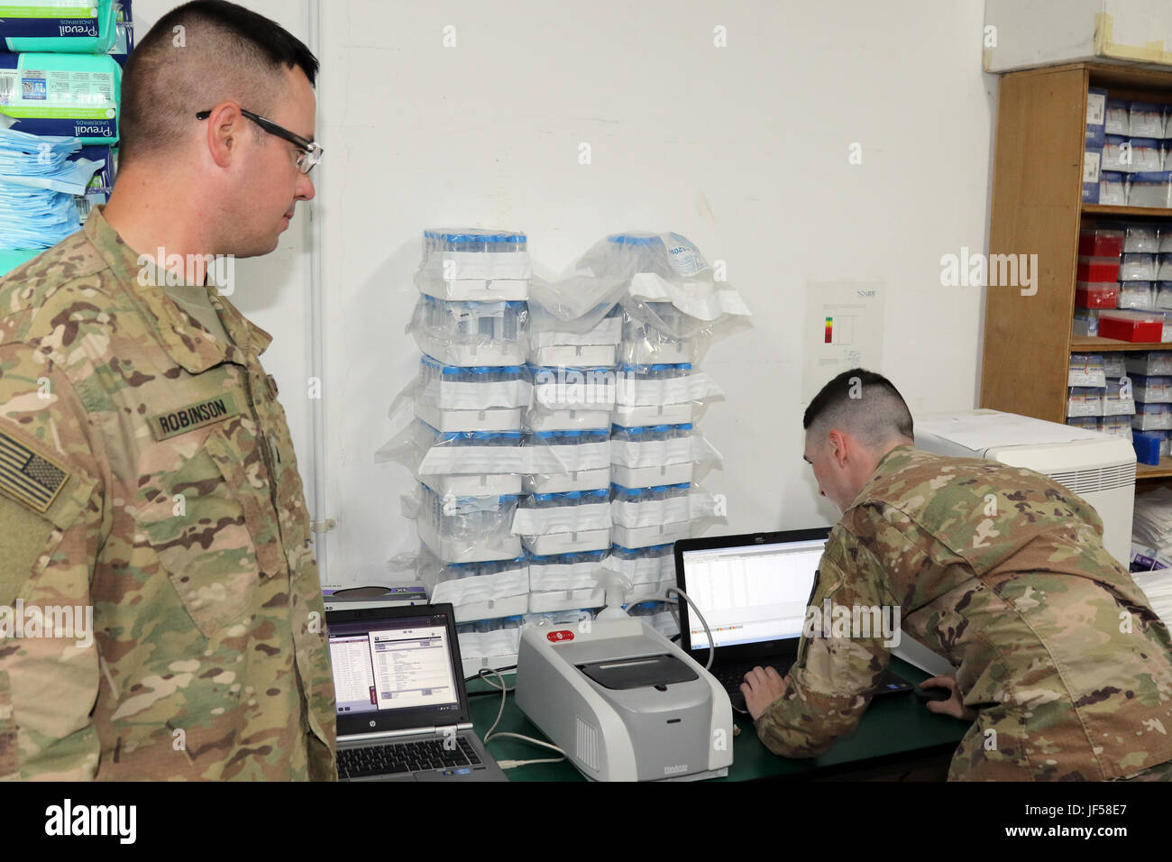 U.S. Army Sgt. Stephen Robinson (left), microbiologist noncommissioned ...