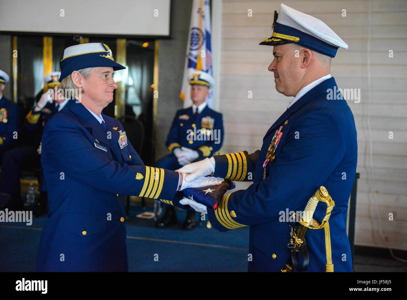 Capt. Samuel Jordan is handed a folded American flag during his ...