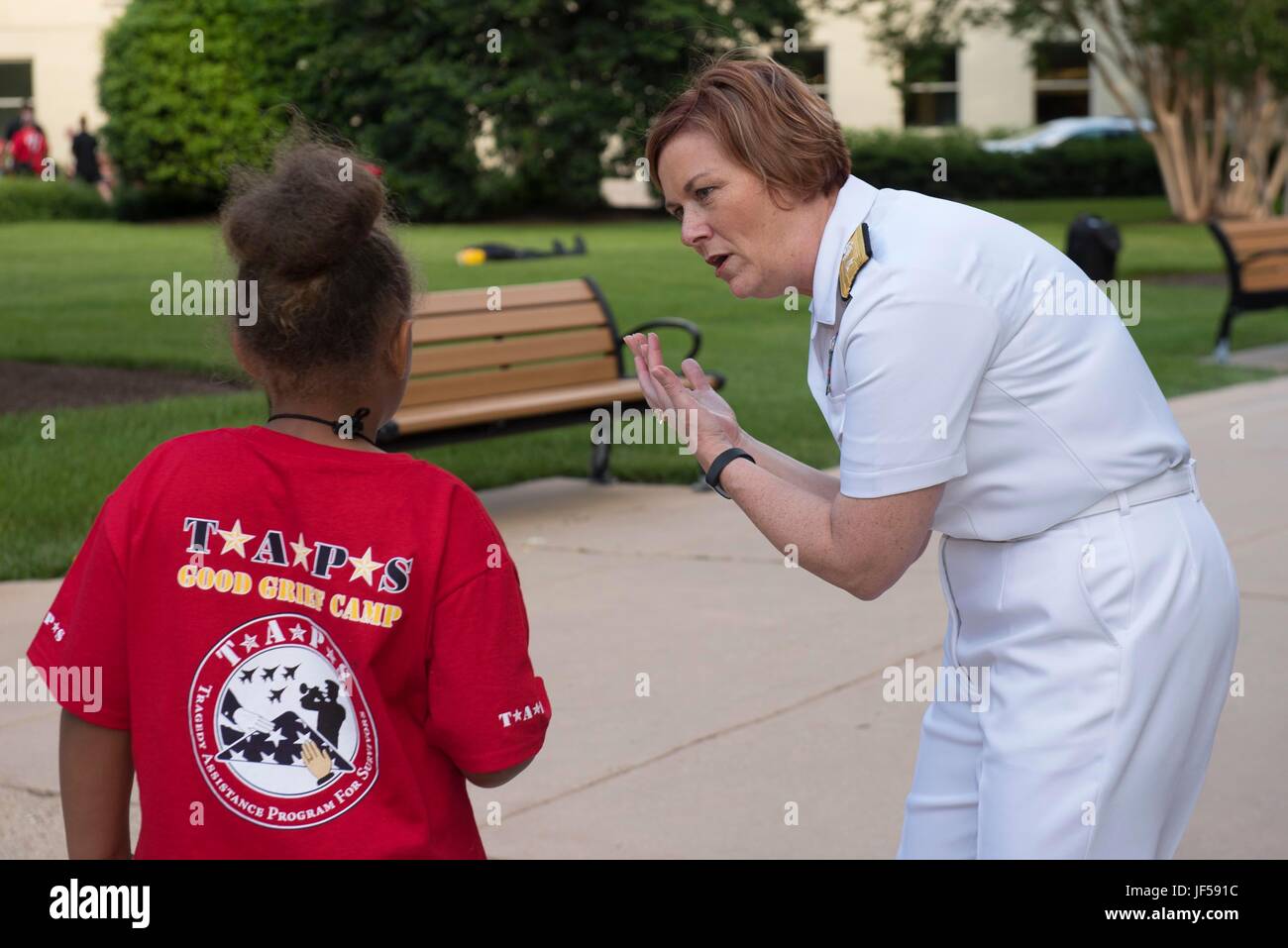 A U.S. Navy official interacts with participants of the 23rd TAPS ...