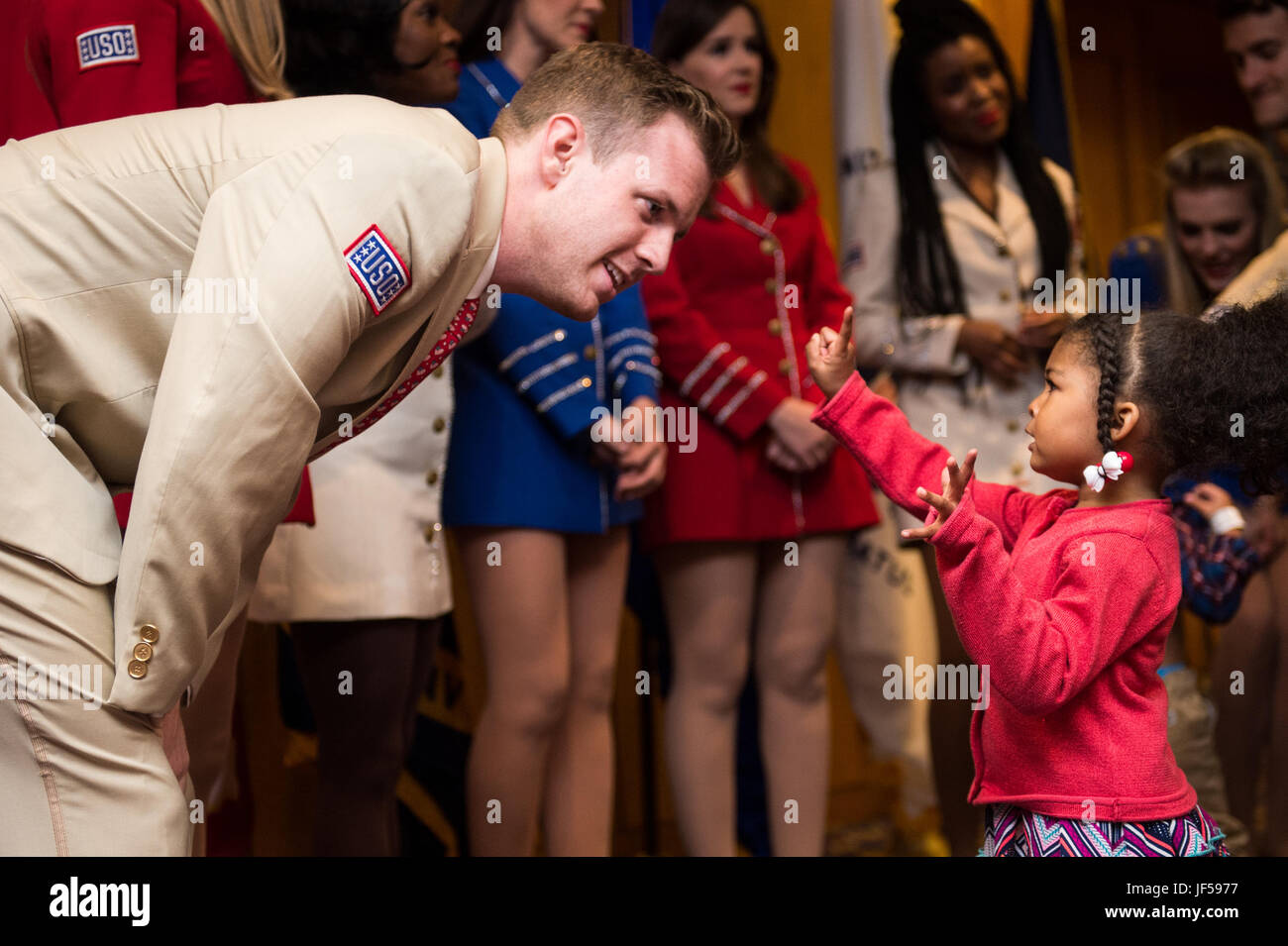 A USO Show Troupe performer speaks with a little girl after the Tragedy ...