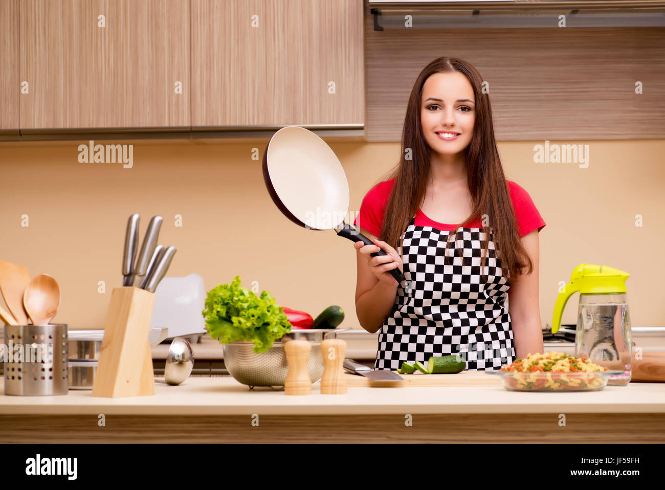 Young woman housewife working in the kitchen Stock Photo - Alamy