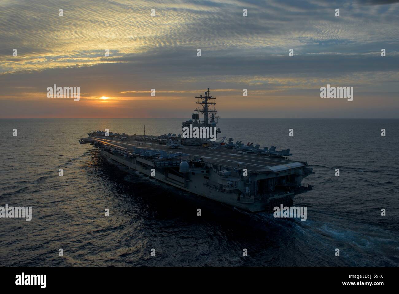 The forward-deployed aircraft carrier USS Ronald Reagan patrols waters ...