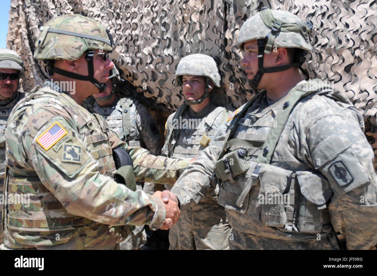 Maj. Gen. Lee Tafanelli, the adjutant general of the Kansas, shakes a ...