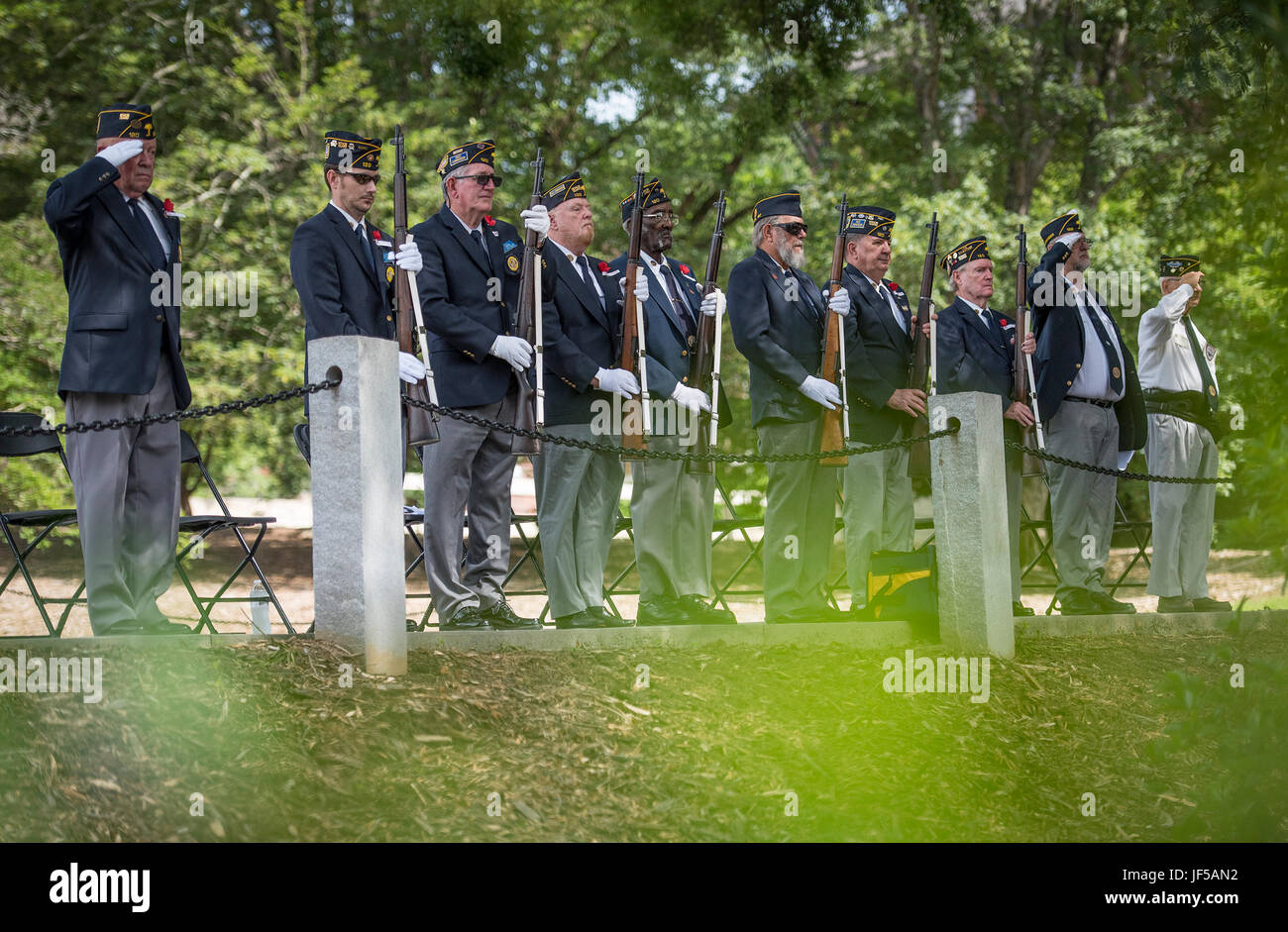Marine Corps League Detachment 1131 members salute during a Memorial ...