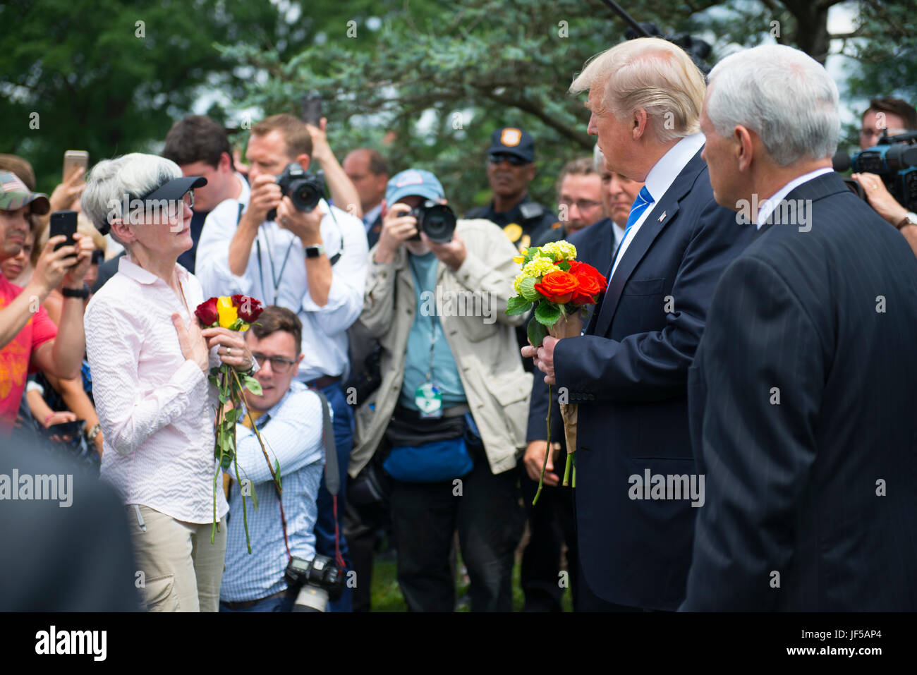 President Donald J. Trump and Vice President Mike Pence speak with a visitor in Section 60 of ...