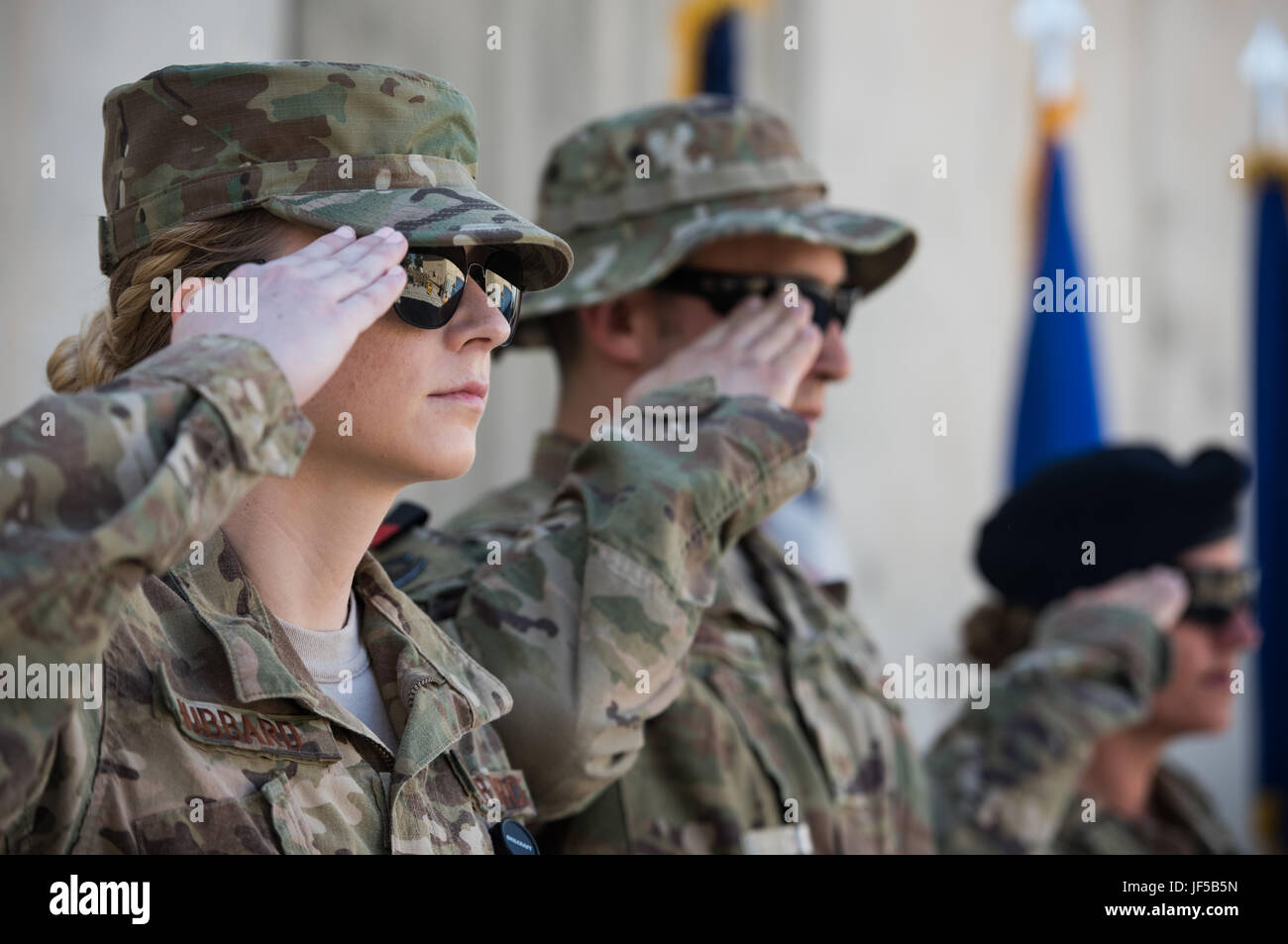 Airmen salute during the singing of the National Anthem at Bagram ...