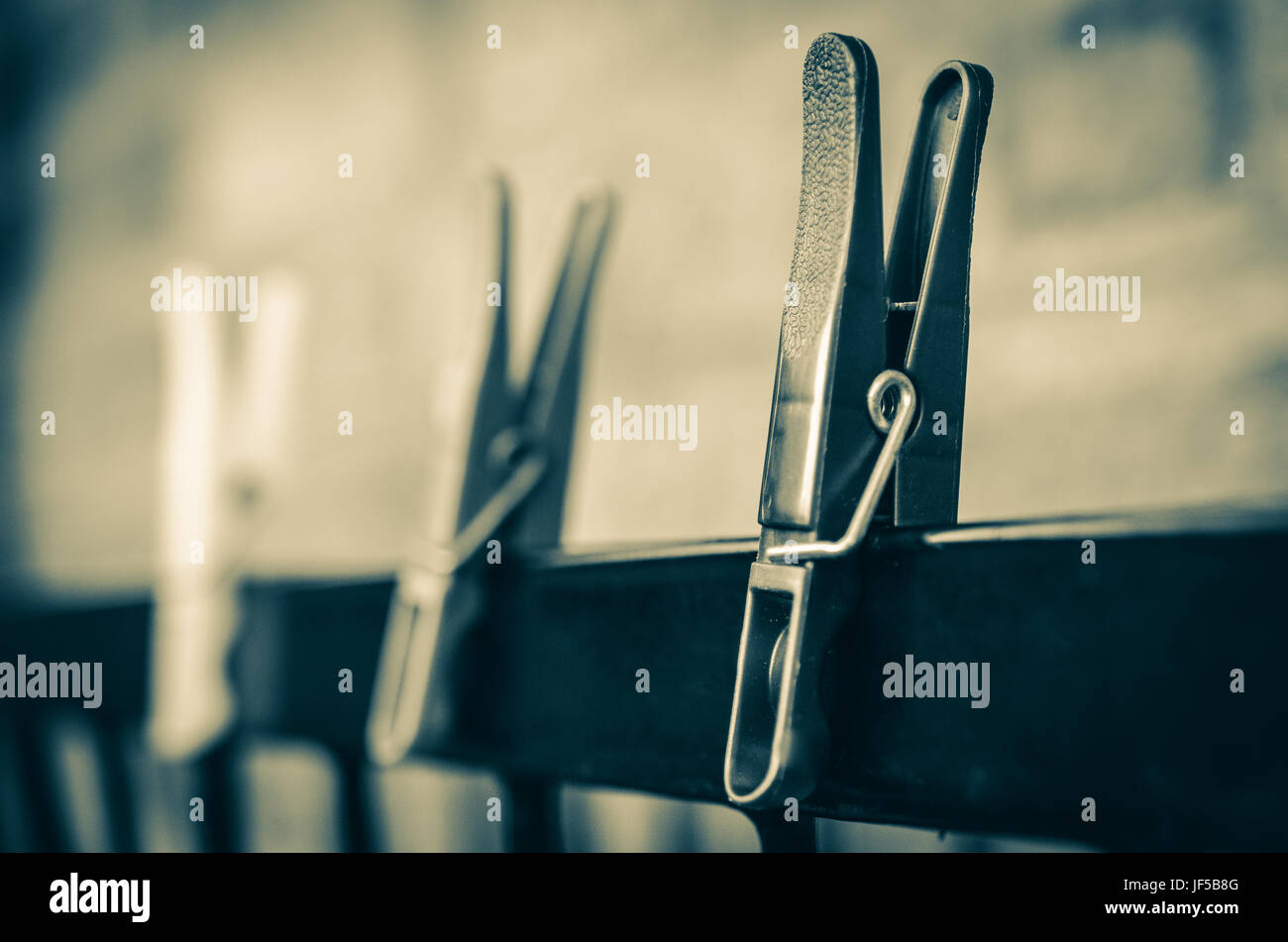 clothes pegs pinned to a bench with brick wall in a background Stock ...