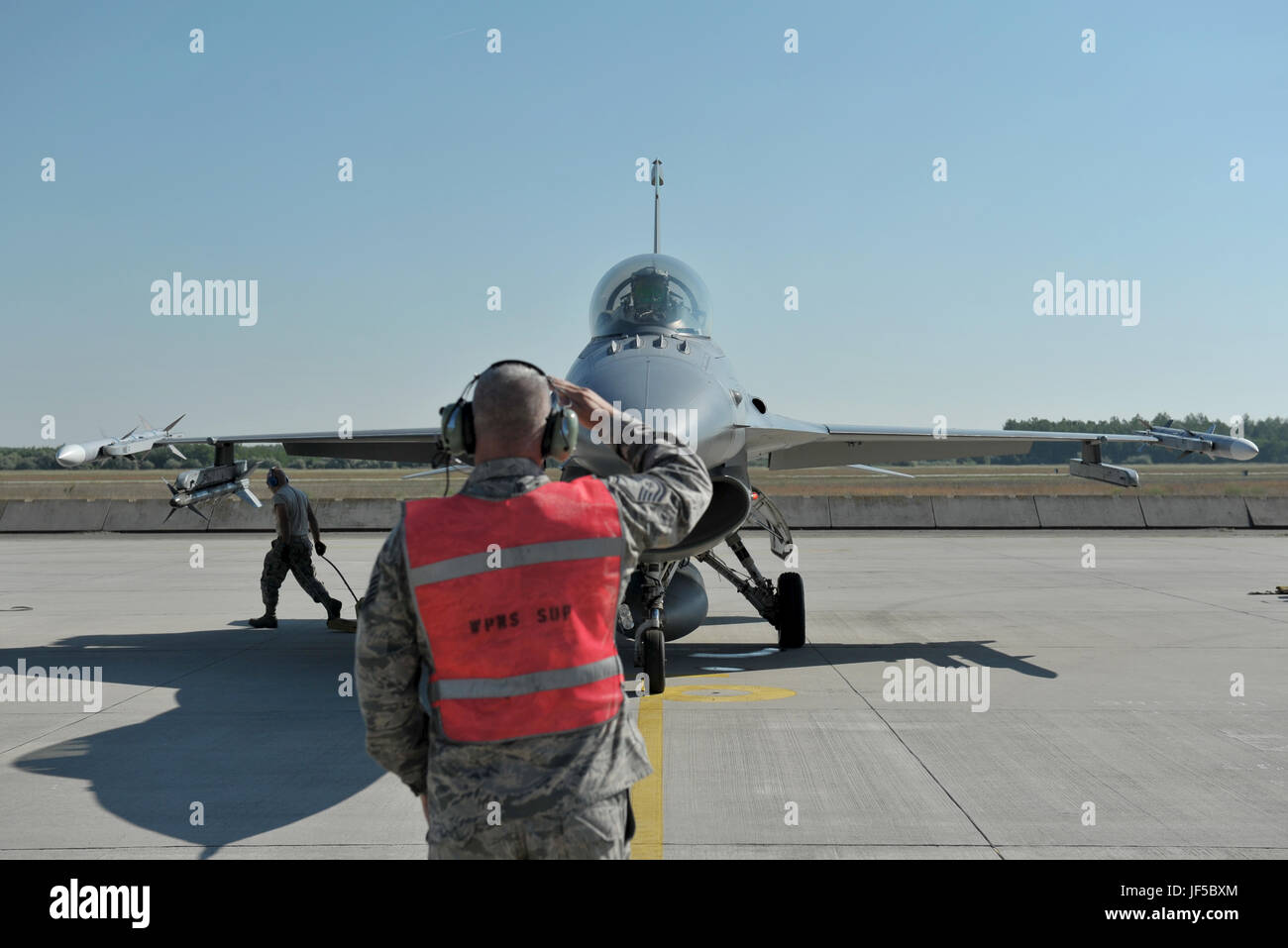 A weapons loader from the 180th Fighter Wing monitors preflight checks ...