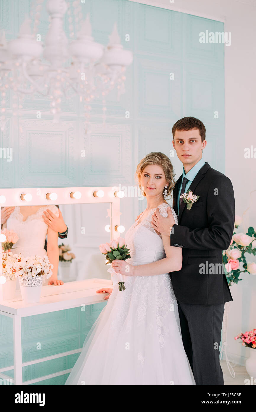 Happy couple. Wedding photo shoot in the white studio with wedding ...