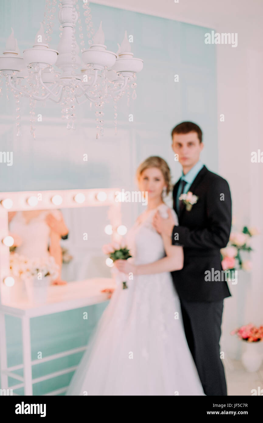 Happy couple. Wedding photo shoot in the white studio with wedding ...