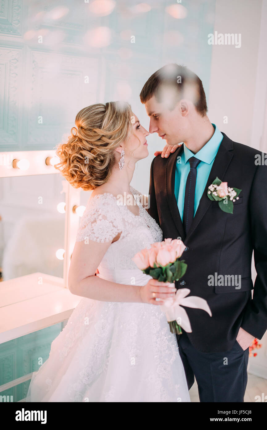 Happy couple. Wedding photo shoot in the white studio with wedding ...