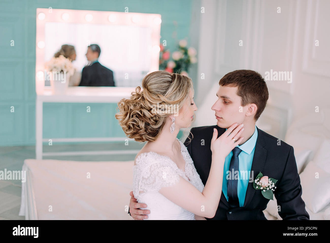 Happy couple. Wedding photo shoot in the white studio with wedding ...