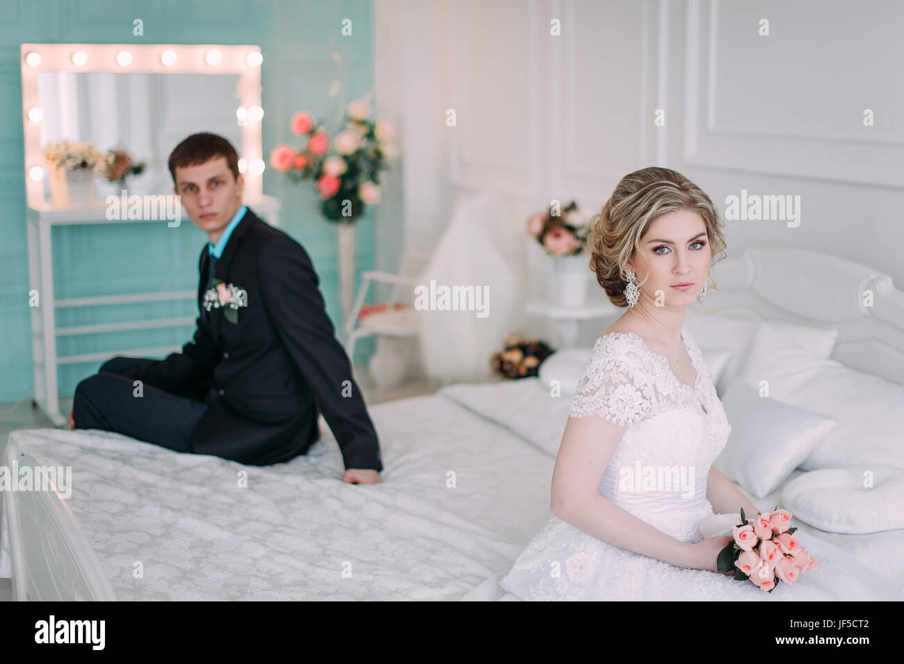 Happy couple. Wedding photo shoot in the white studio with wedding ...