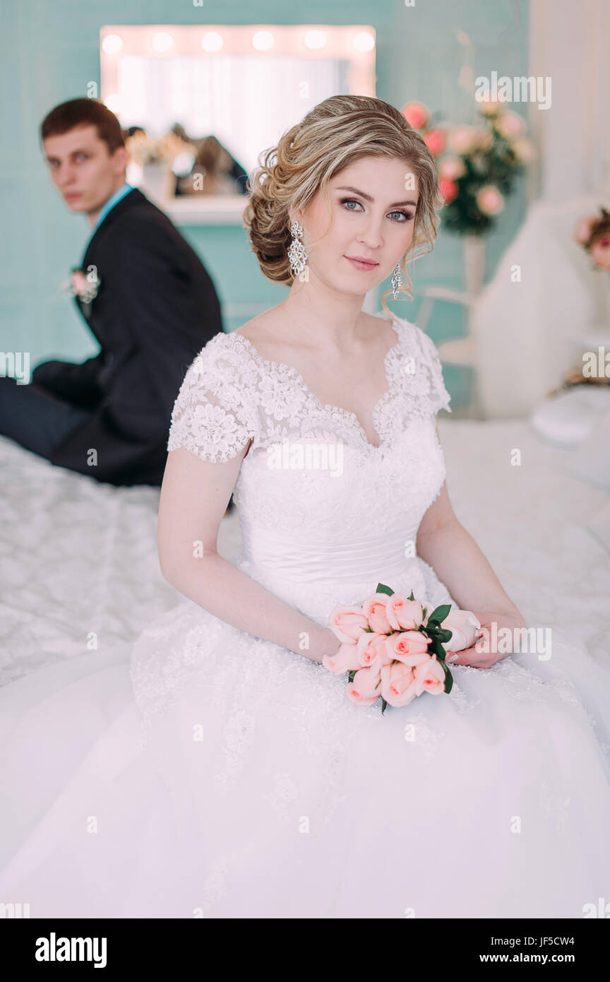 Happy couple. Wedding photo shoot in the white studio with wedding ...