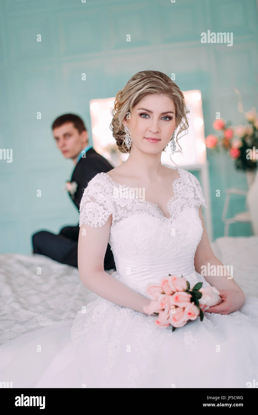 Happy couple. Wedding photo shoot in the white studio with wedding ...