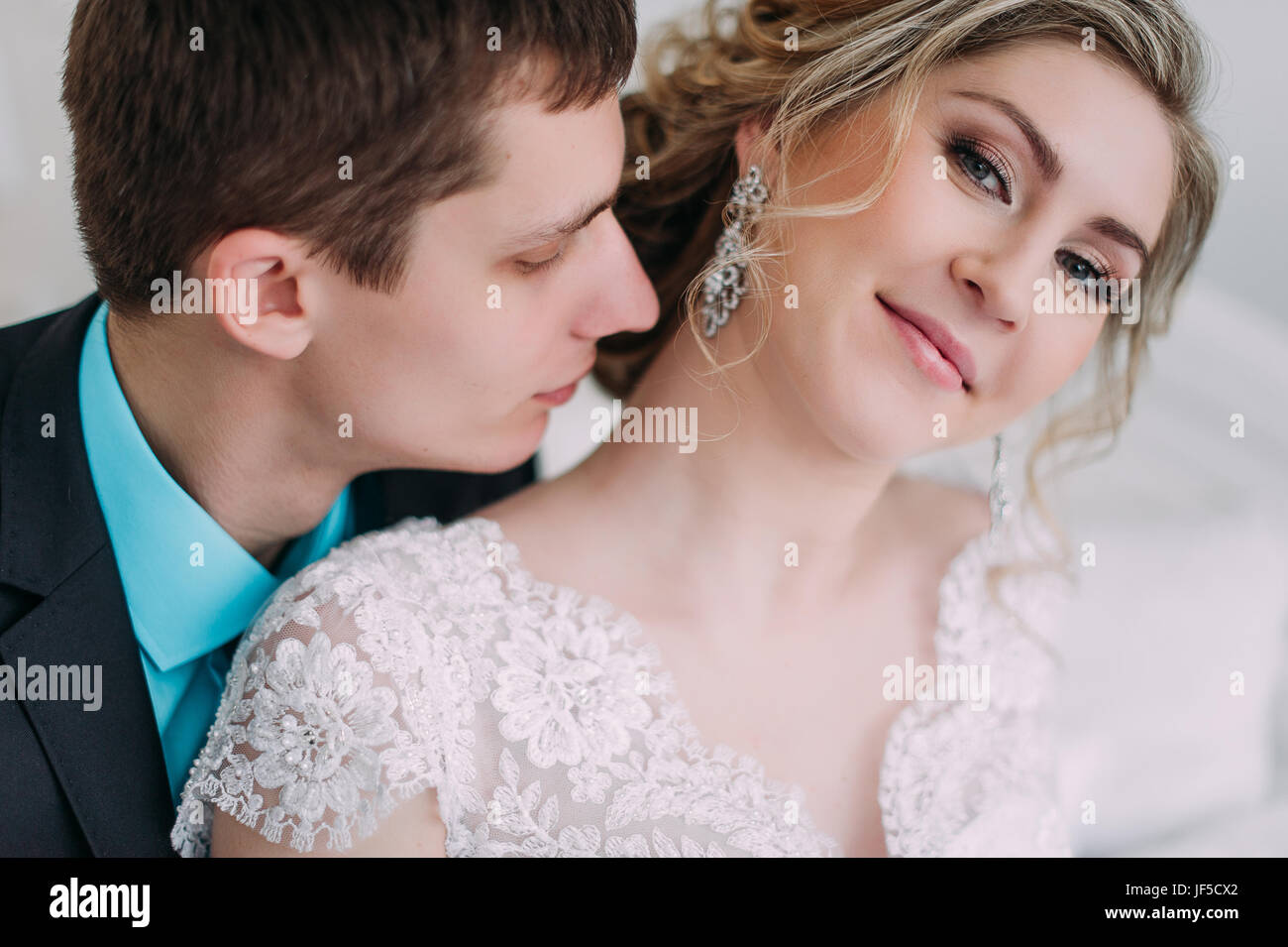 Happy couple. Wedding photo shoot in the white studio with wedding ...
