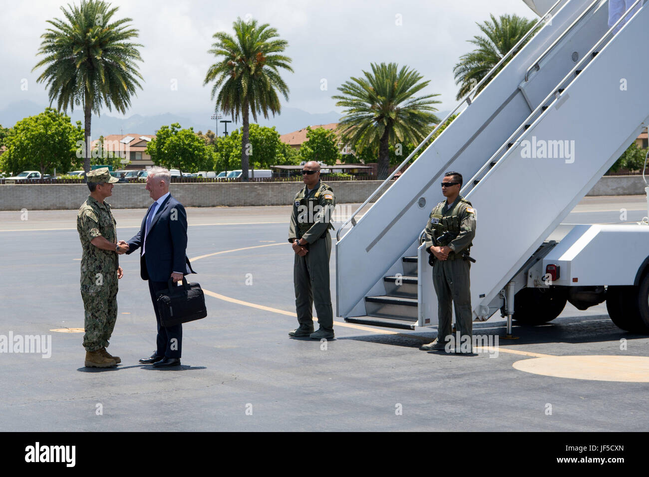 Secretary of Defense Jim Mattis is greeted by Adm. Harry Harris, the ...