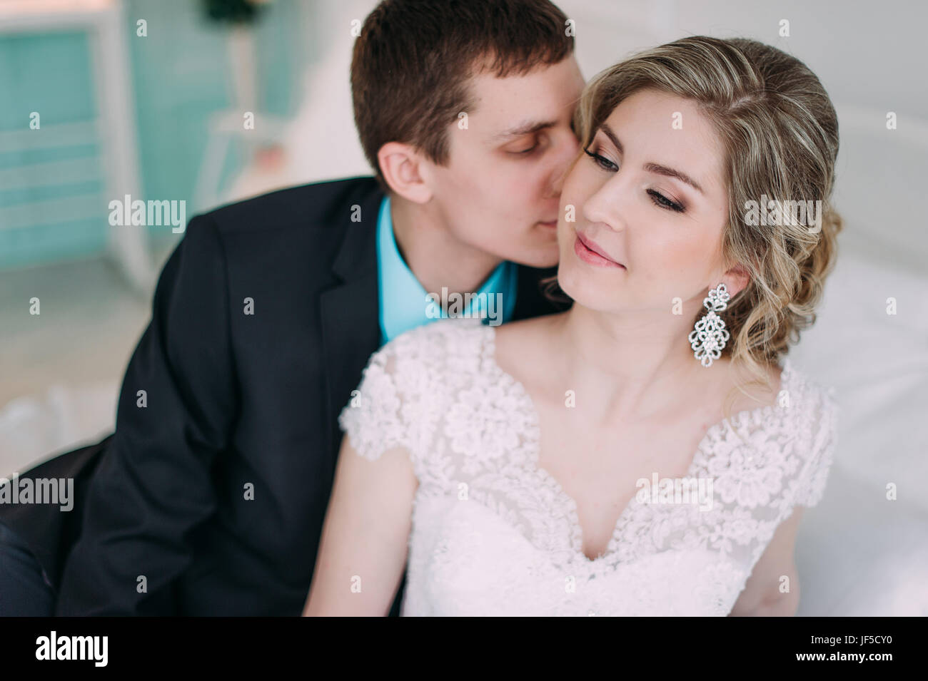 Happy couple. Wedding photo shoot in the white studio with wedding ...