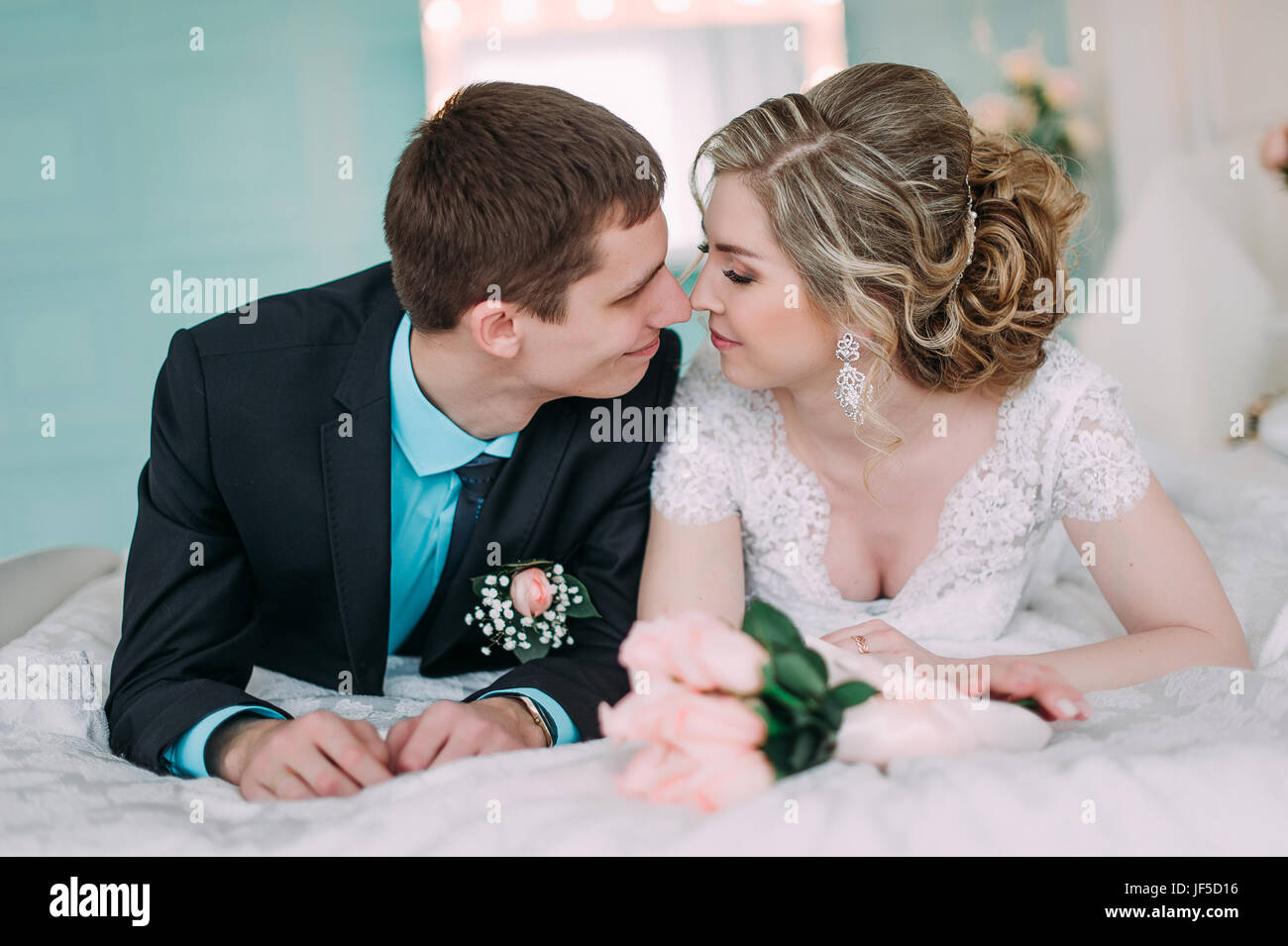 Happy couple. Wedding photo shoot in the white studio with wedding ...