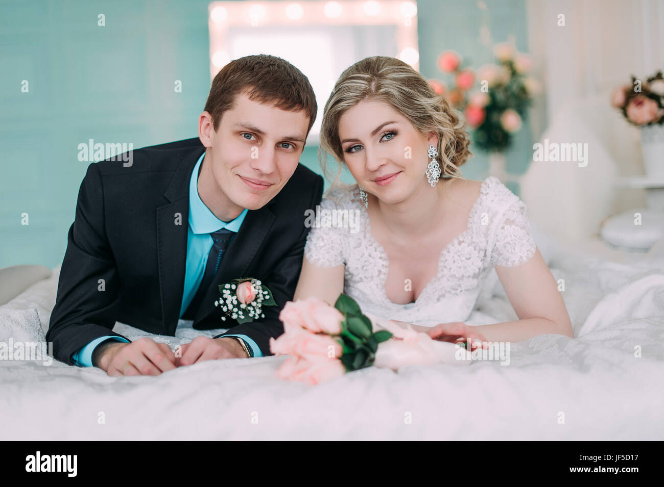 Happy couple. Wedding photo shoot in the white studio with wedding ...