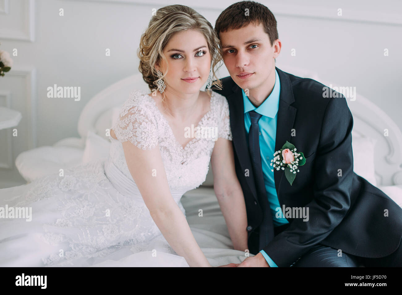 Happy couple. Wedding photo shoot in the white studio with wedding ...