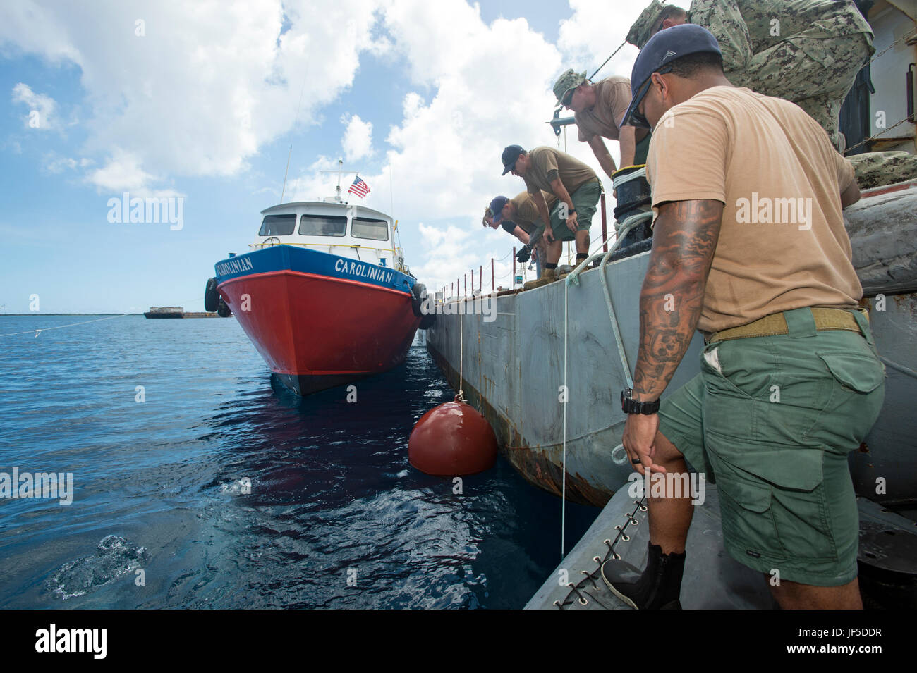 Sailors assigned to Underwater Construction Team (UCT) 2 watch as ...