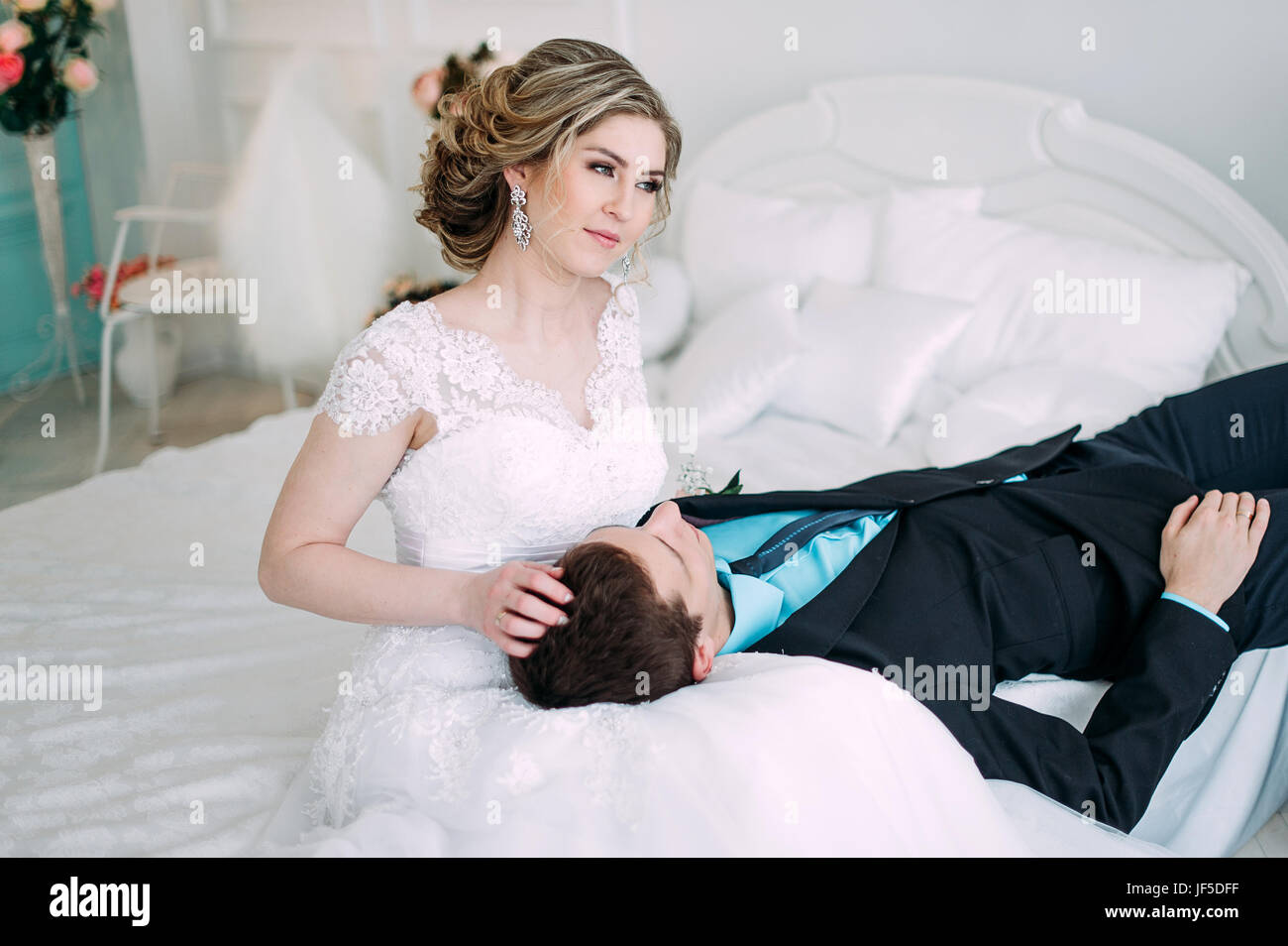 Happy couple. Wedding photo shoot in the white studio with wedding ...