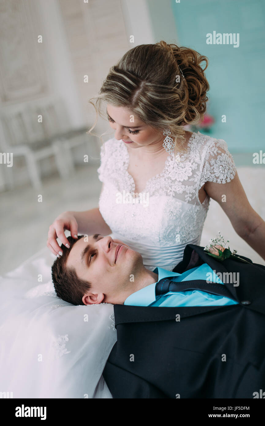 Happy couple. Wedding photo shoot in the white studio with wedding ...