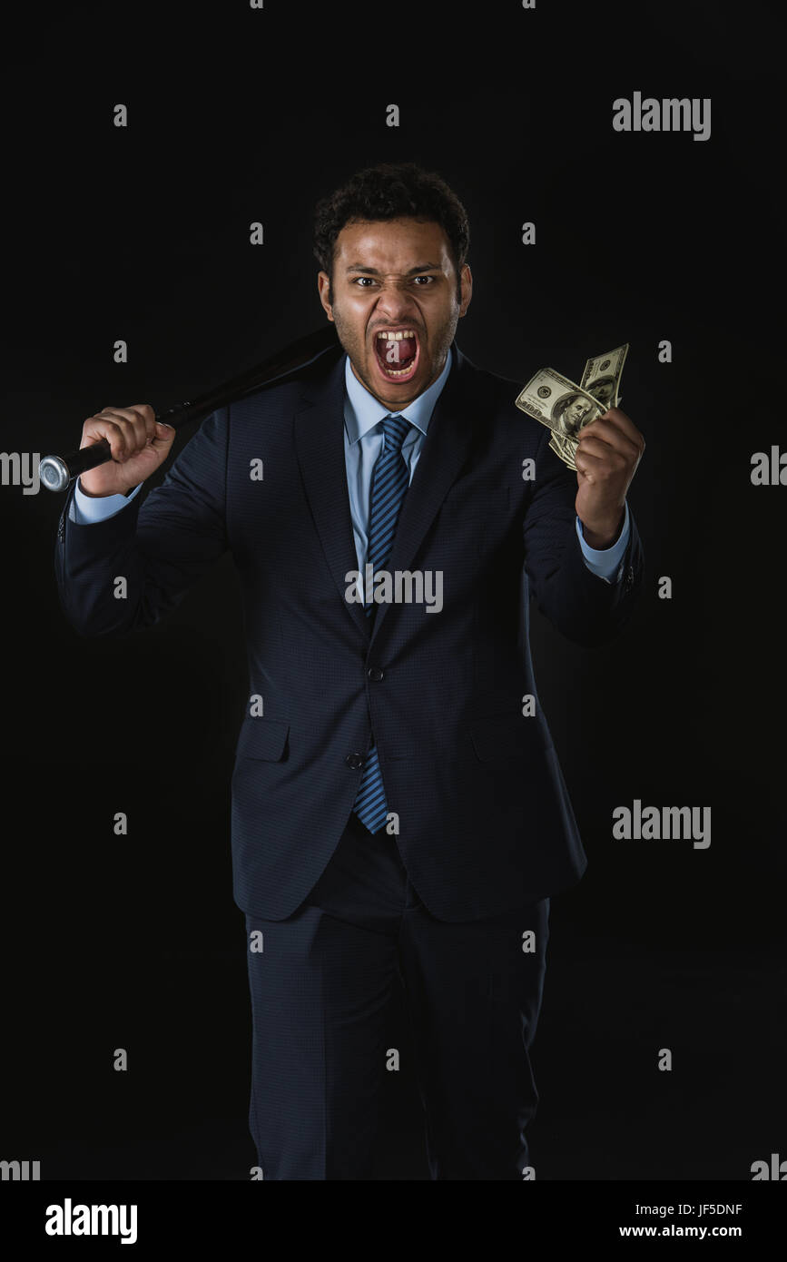 Screaming businessman holding dollar banknotes and baseball bat looking ...