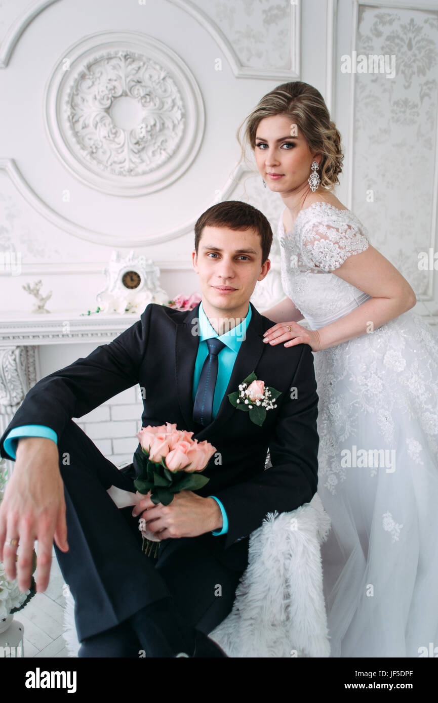 Happy couple. Wedding photo shoot in the white studio with wedding ...