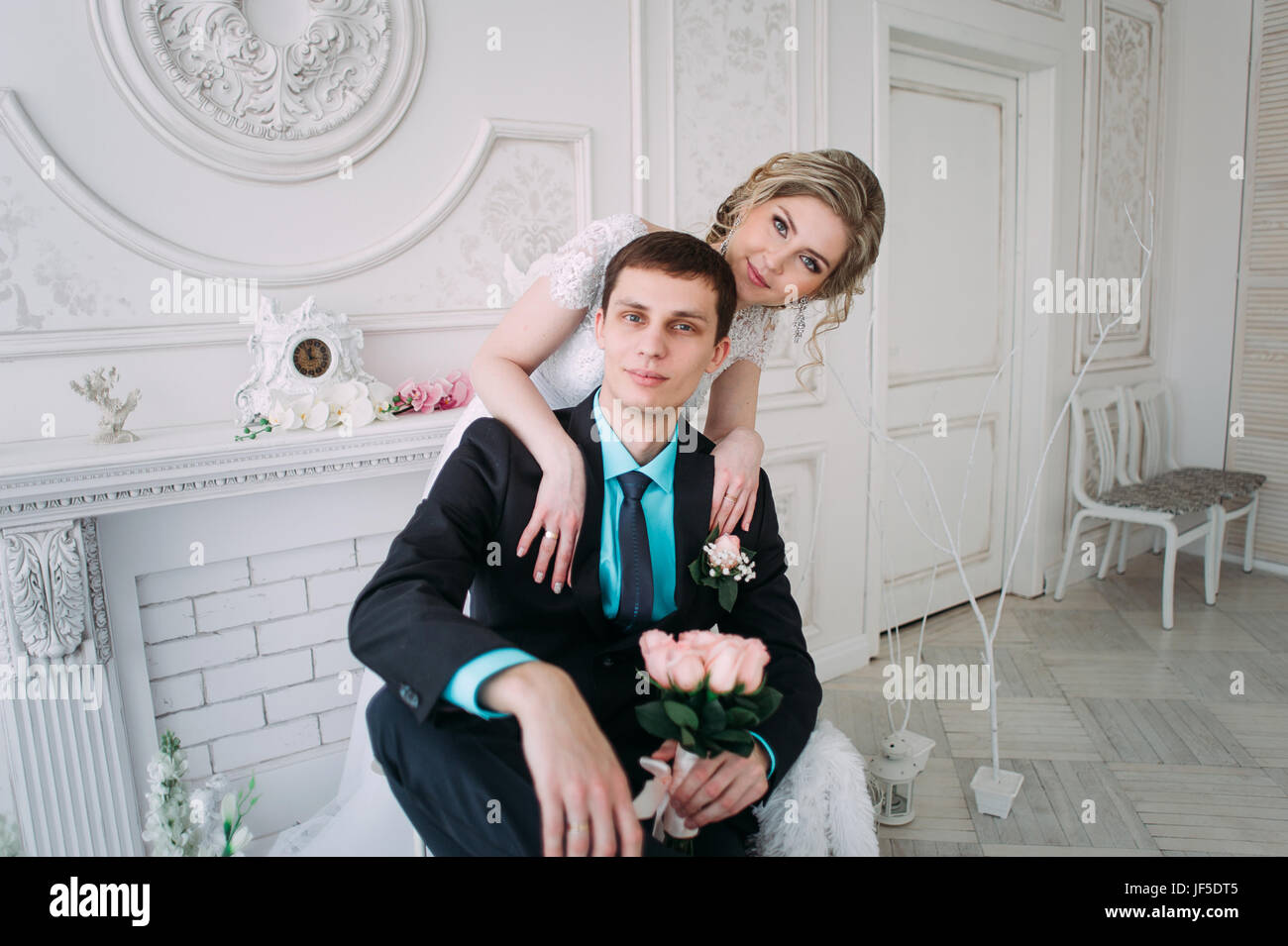 Happy couple. Wedding photo shoot in the white studio with wedding ...