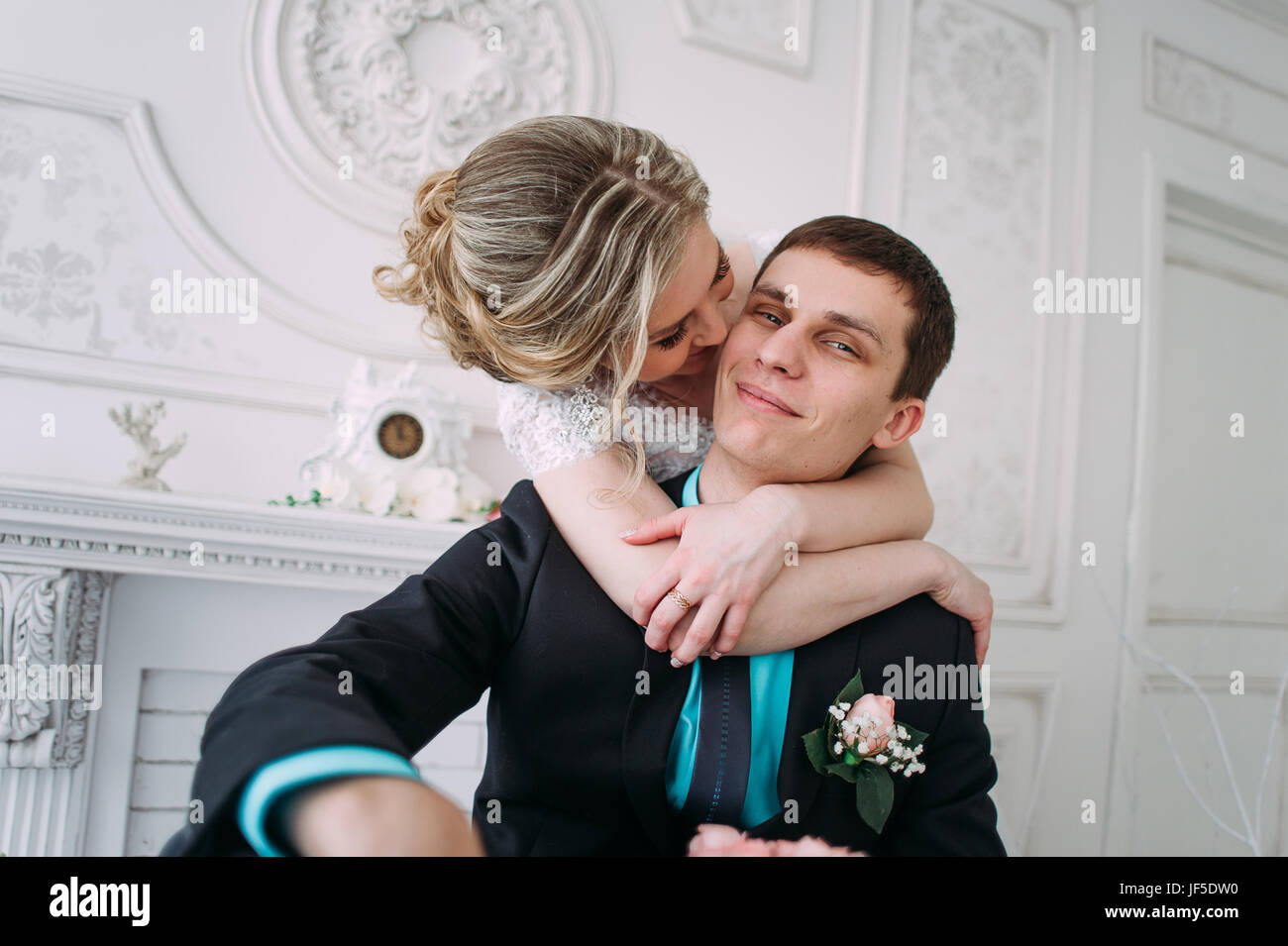 Happy couple. Wedding photo shoot in the white studio with wedding ...