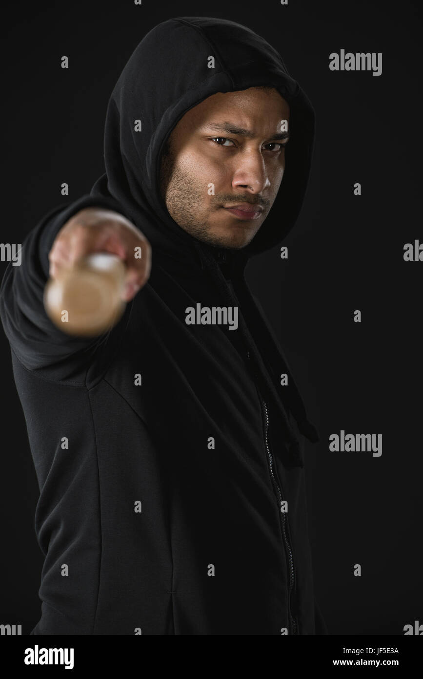 young african american robber in zoodie with baseball bat isolated on ...