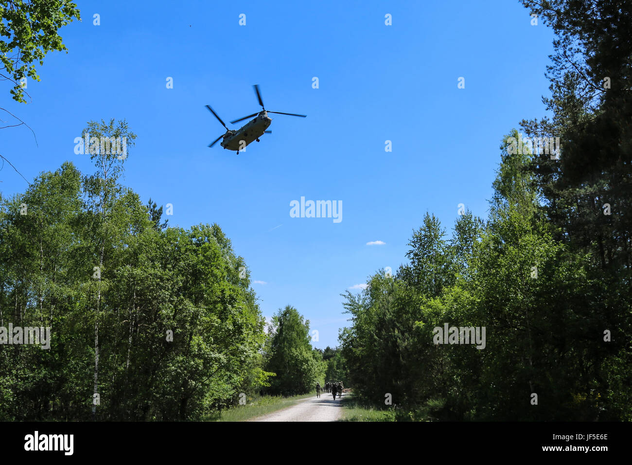 A CH-47 Chinook helicopter flies overhead Macedonian Army Rangers while ...