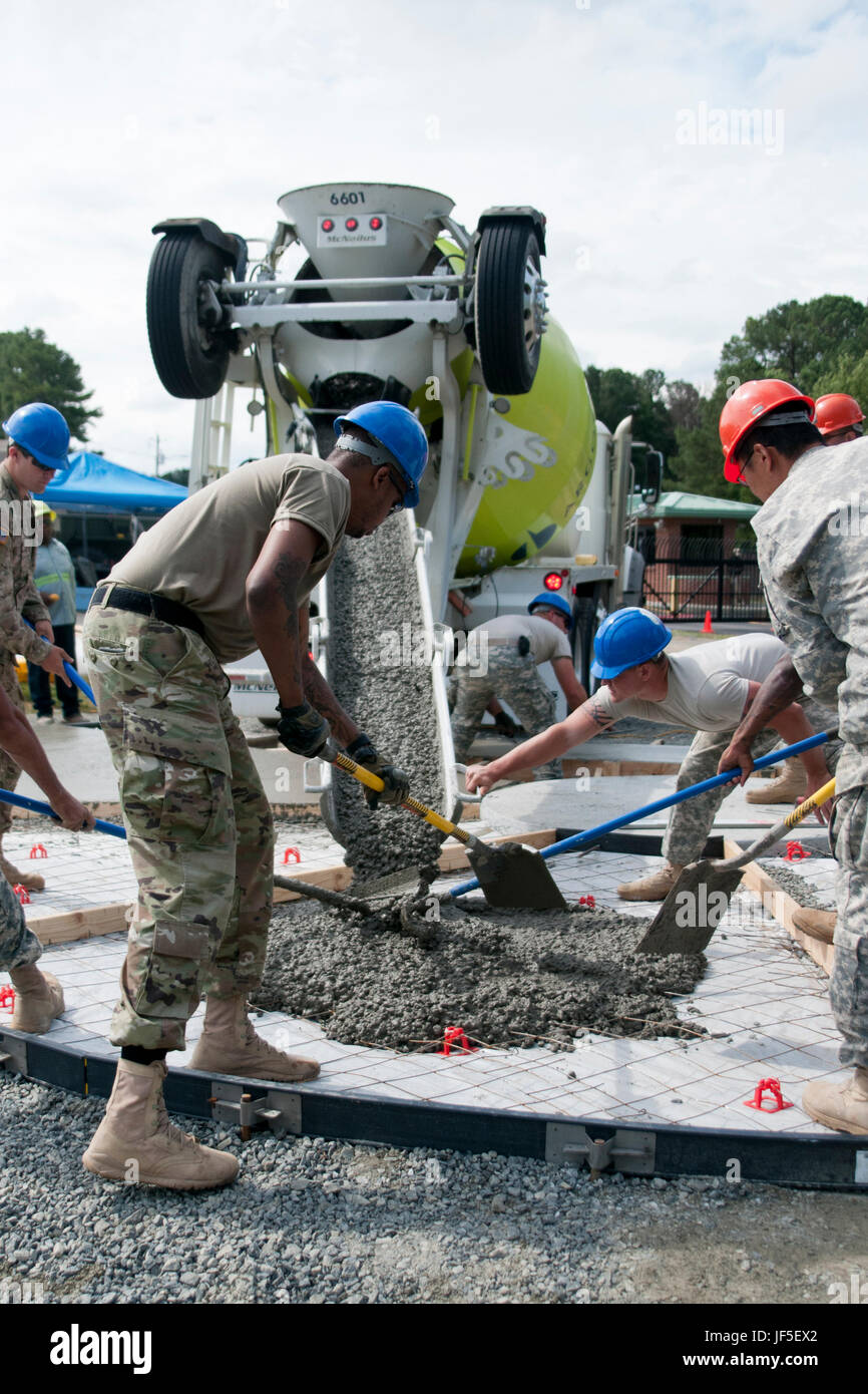 Soldiers of the 429th Concrete Platoon pour concrete for a construction ...