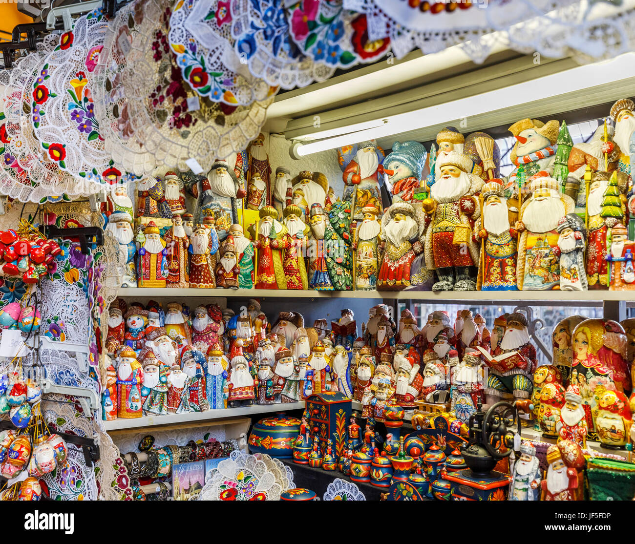 Display of brightly coloured traditional carved wooden figures in a ...