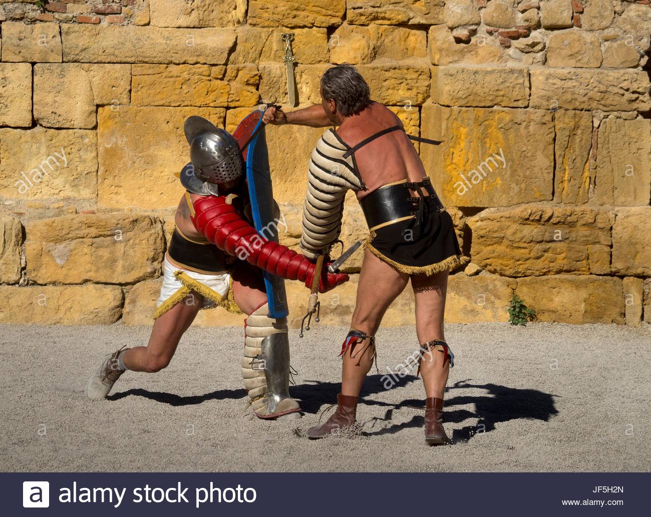 Men dressed as a Roman gladiators fighting in a historical recreation ...