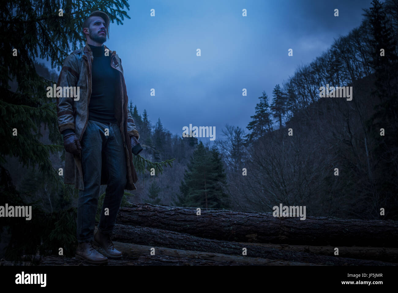 Young man in the forest at night Stock Photo - Alamy