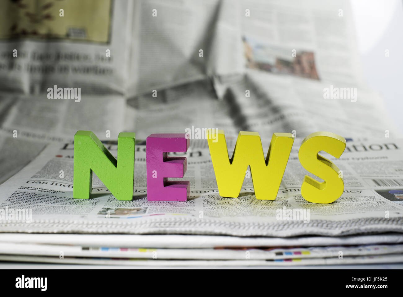 Word news on newspaper Stock Photo - Alamy