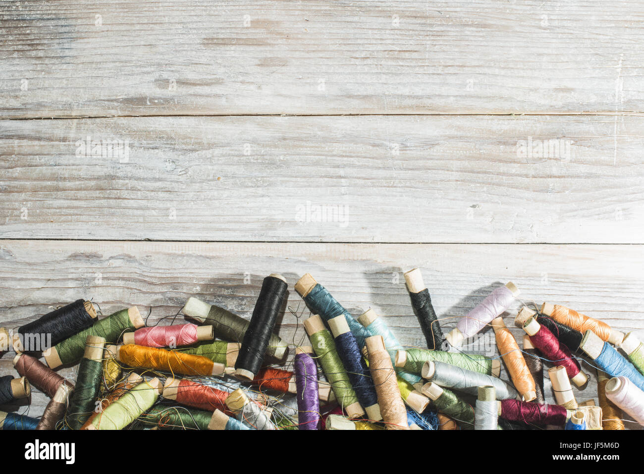 Spools of thread on white wood Stock Photo - Alamy