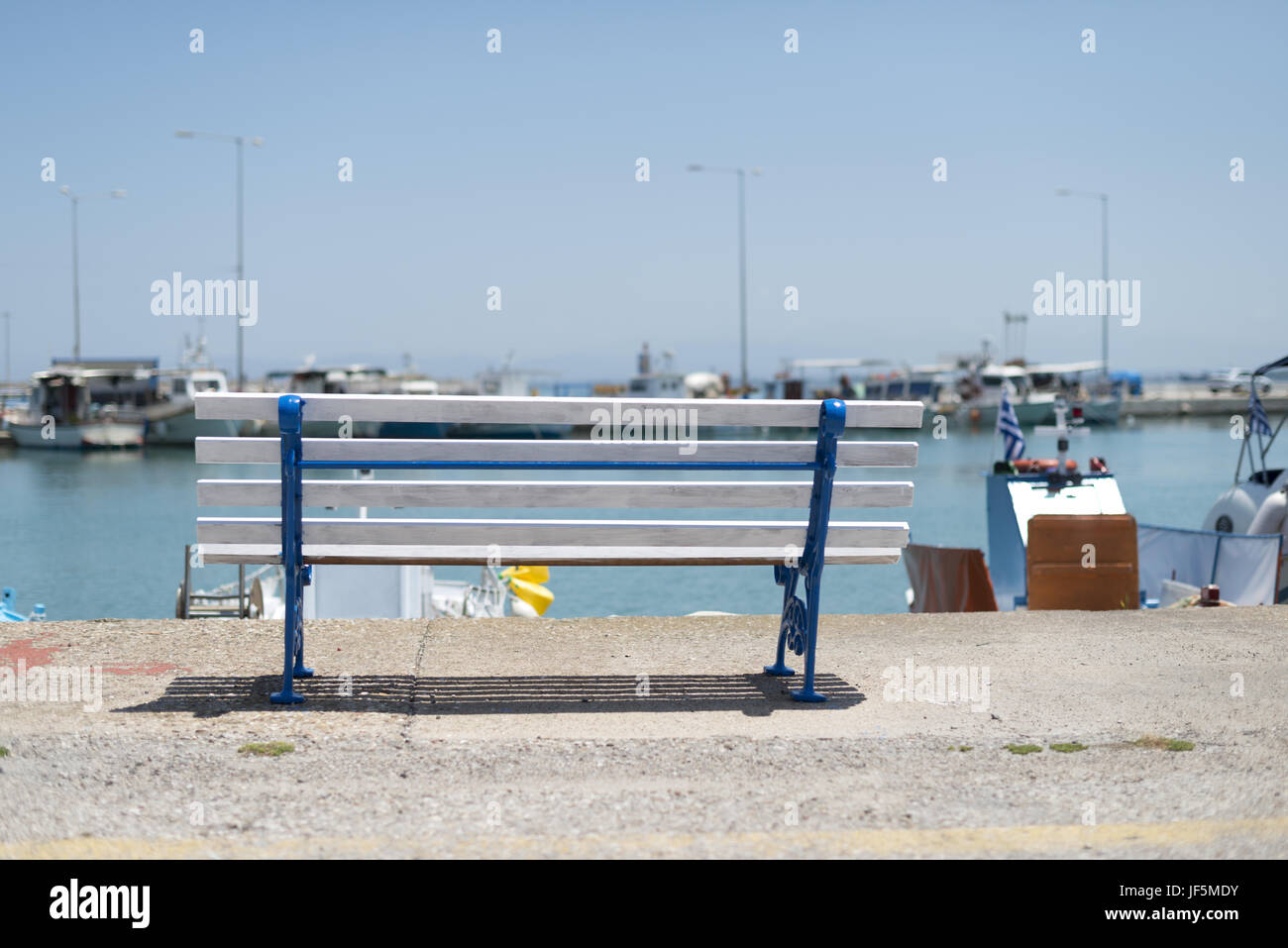 Bench on the beach and boats Stock Photo - Alamy