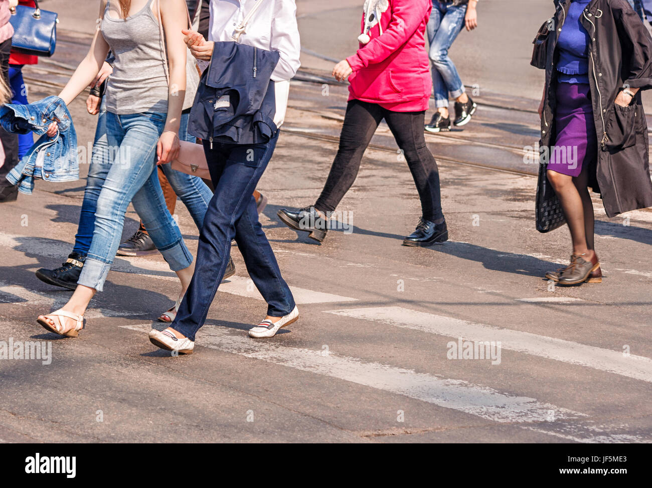 young women feet, crossing an urban street on sunny spring day Stock ...
