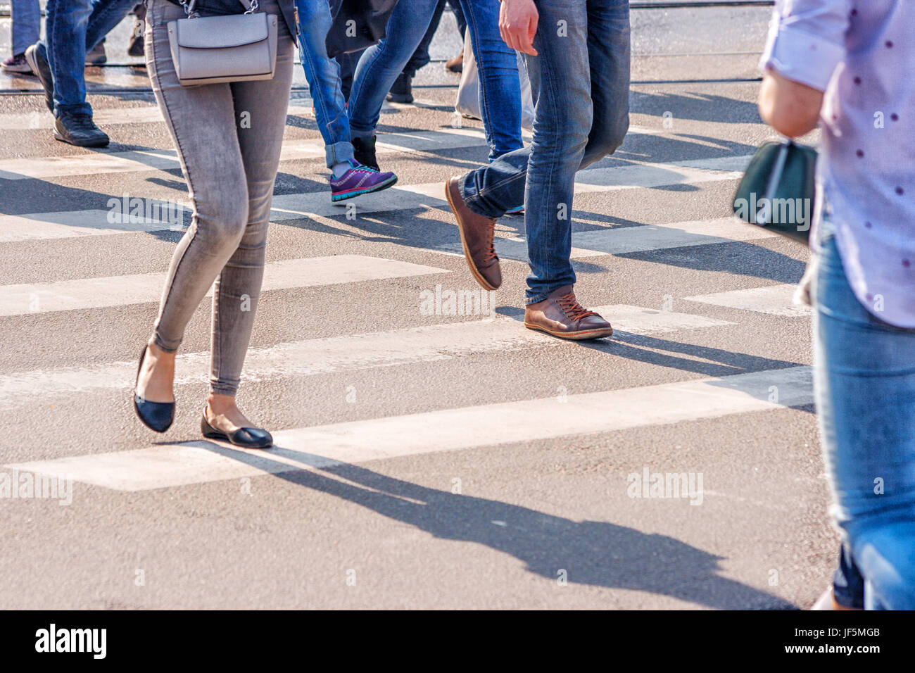 people crossing the pedestrian crossing on sunny spring day Stock Photo ...
