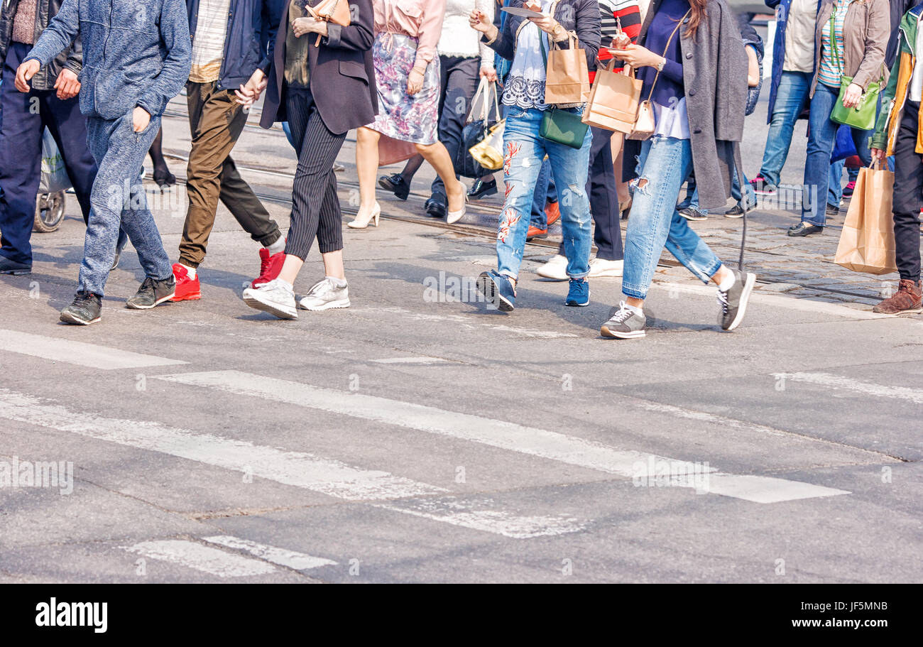 many people crossing the pedestrian crossing on sunny spring day Stock ...