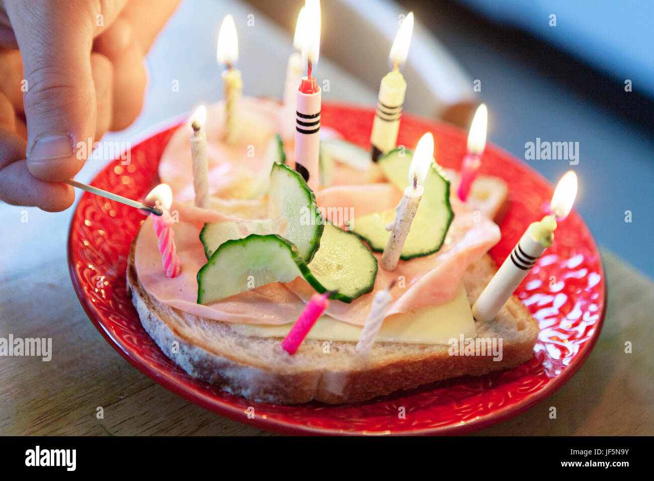 Birthday candles being lit on sandwich Stock Photo - Alamy