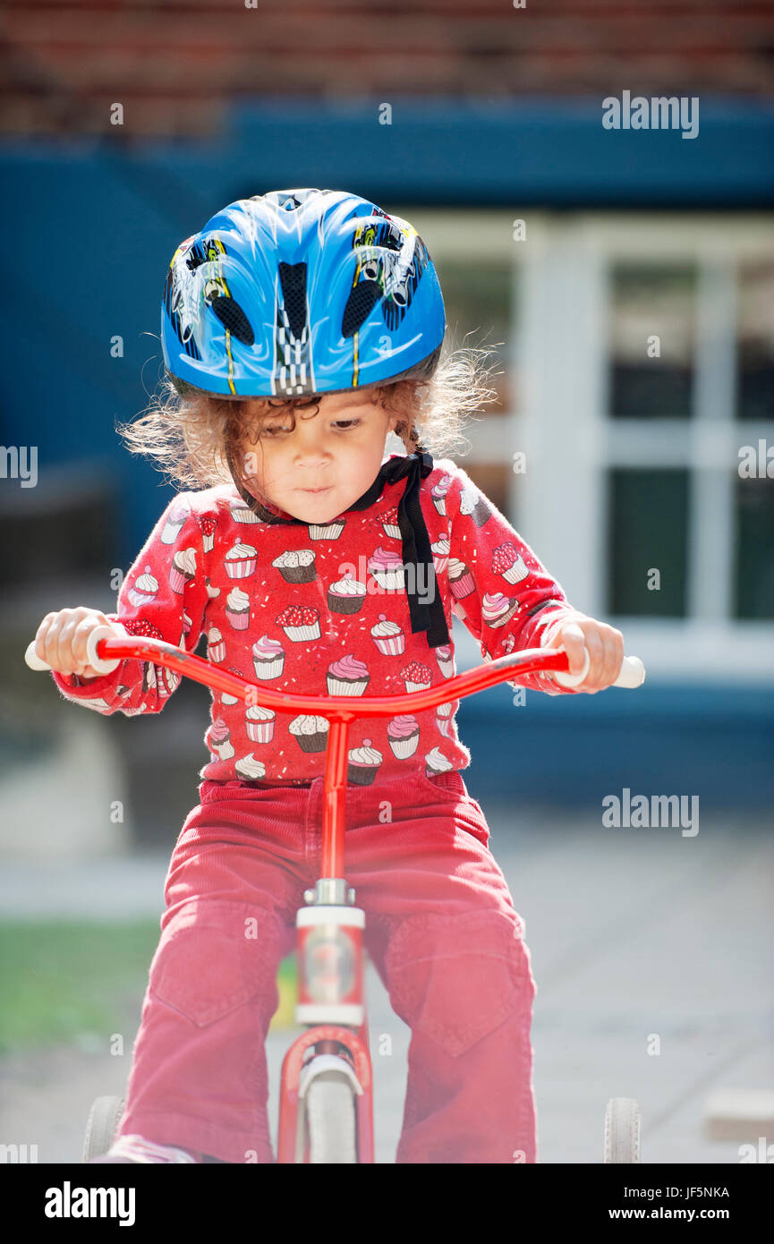 Girl riding small bicycle Stock Photo - Alamy