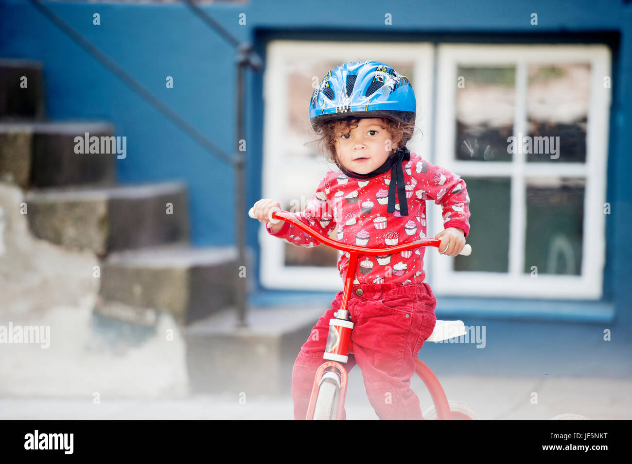 Girl riding small bicycle Stock Photo - Alamy