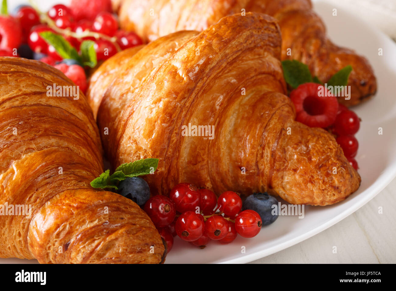 Beautiful pastries: croissants and berries close-up on a plate ...